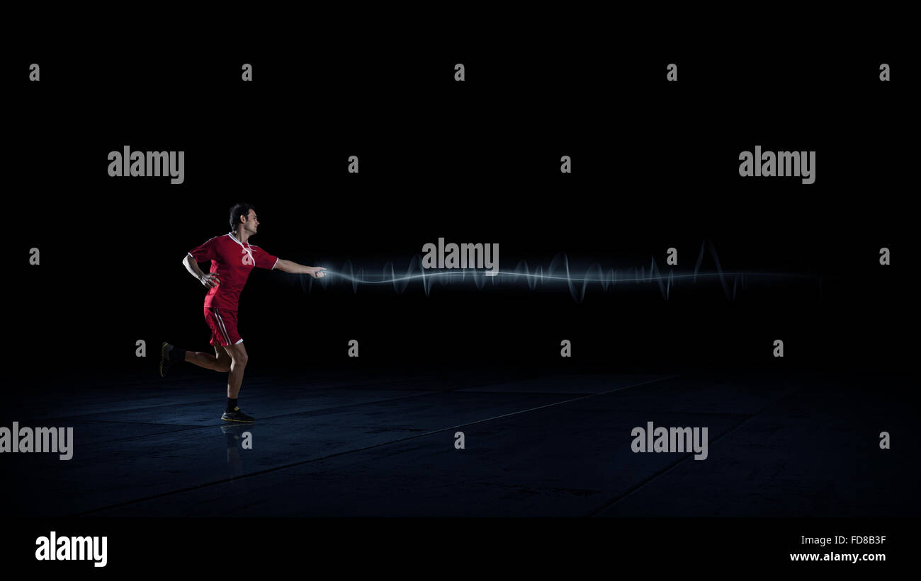 Running man in red sport wear on black background Stock Photo - Alamy