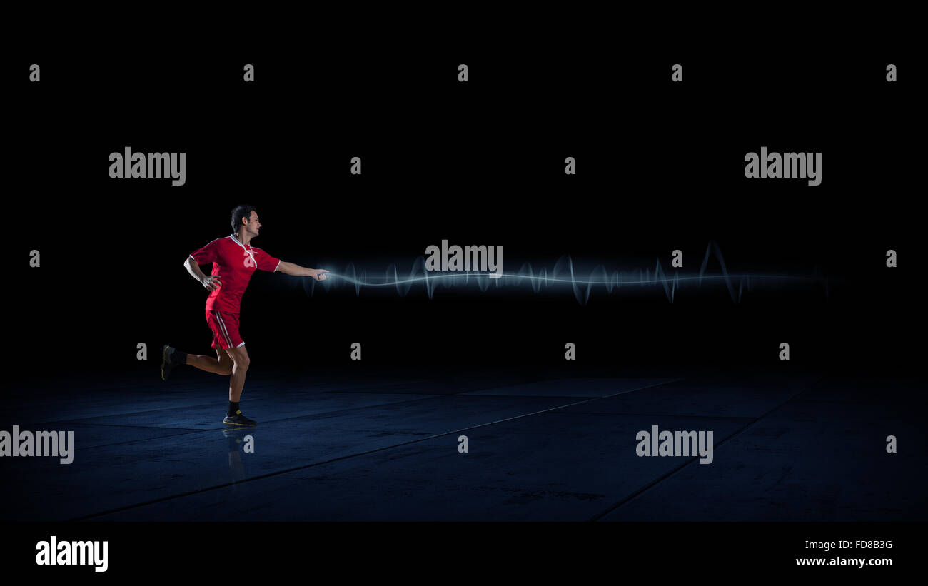 Running man in red sport wear on black background Stock Photo - Alamy