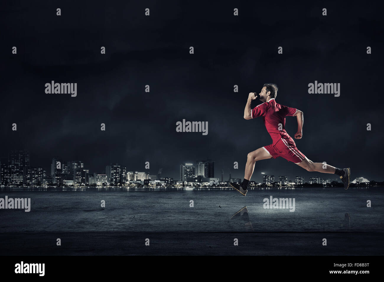 Running man in red sport wear on black background Stock Photo - Alamy