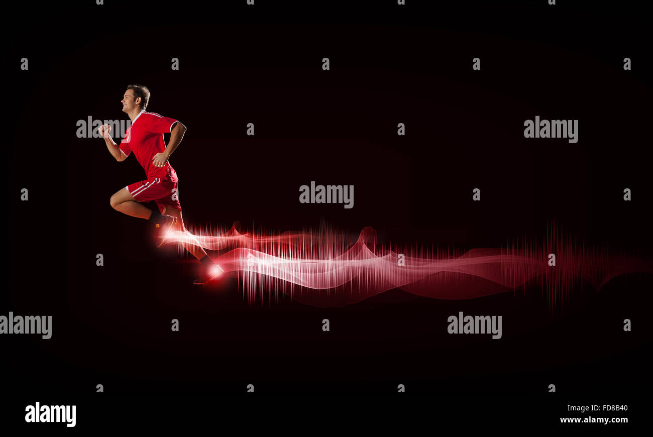 Running man in red sport wear on black background Stock Photo - Alamy