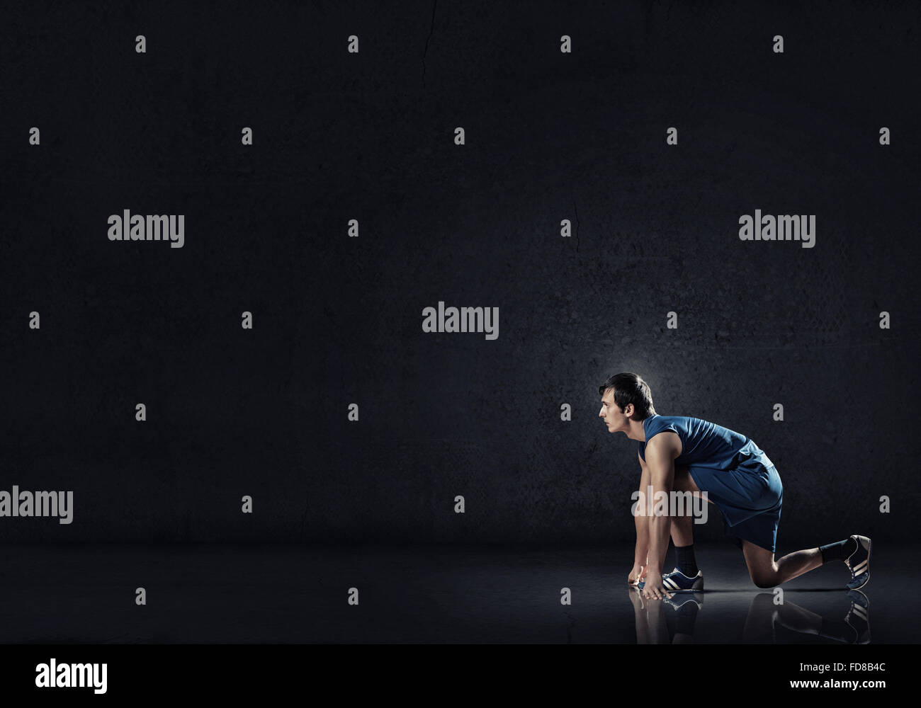 Running man in blue sport wear on black background Stock Photo - Alamy