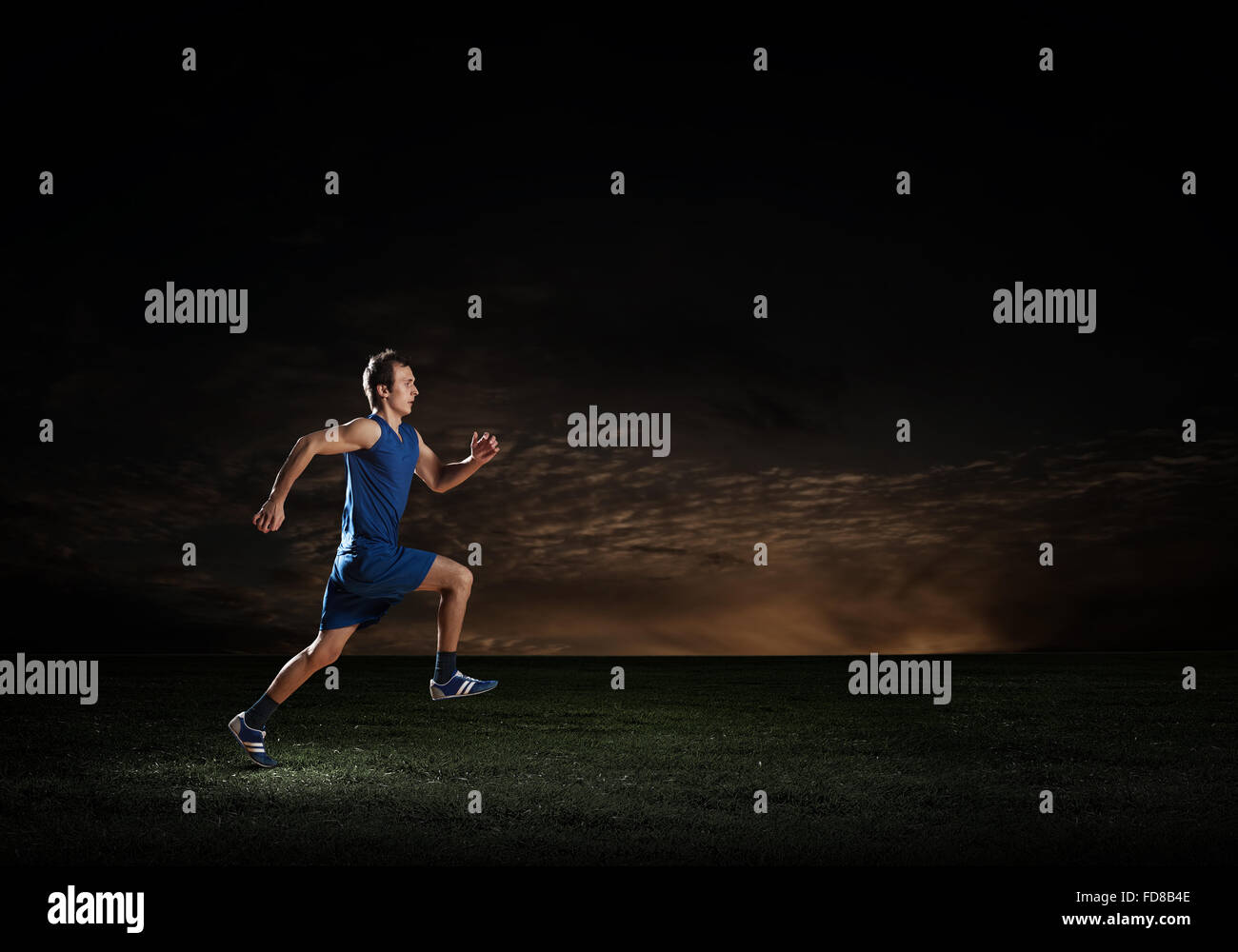 Running man in blue sport wear on black background Stock Photo - Alamy