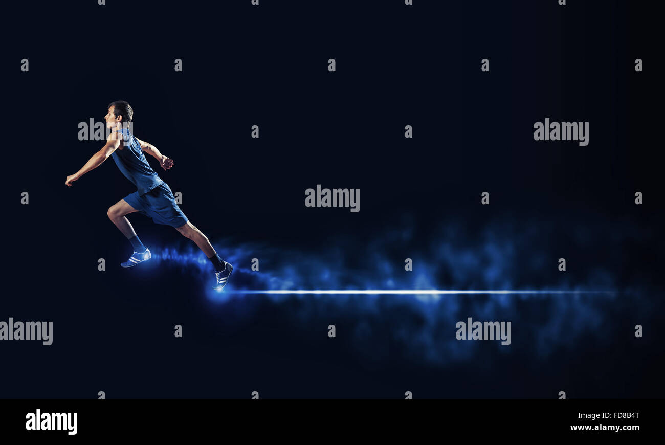 Running man in blue sport wear on black background Stock Photo - Alamy