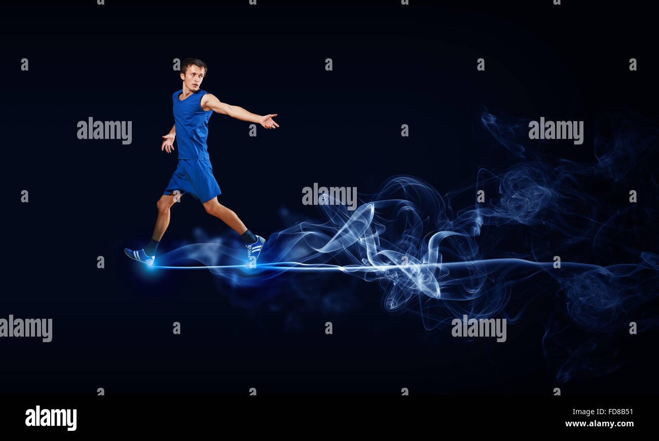 Running man in blue sport wear on black background Stock Photo - Alamy