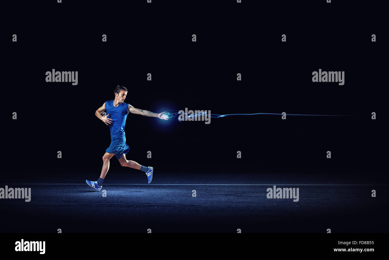 Running man in blue sport wear on black background Stock Photo - Alamy