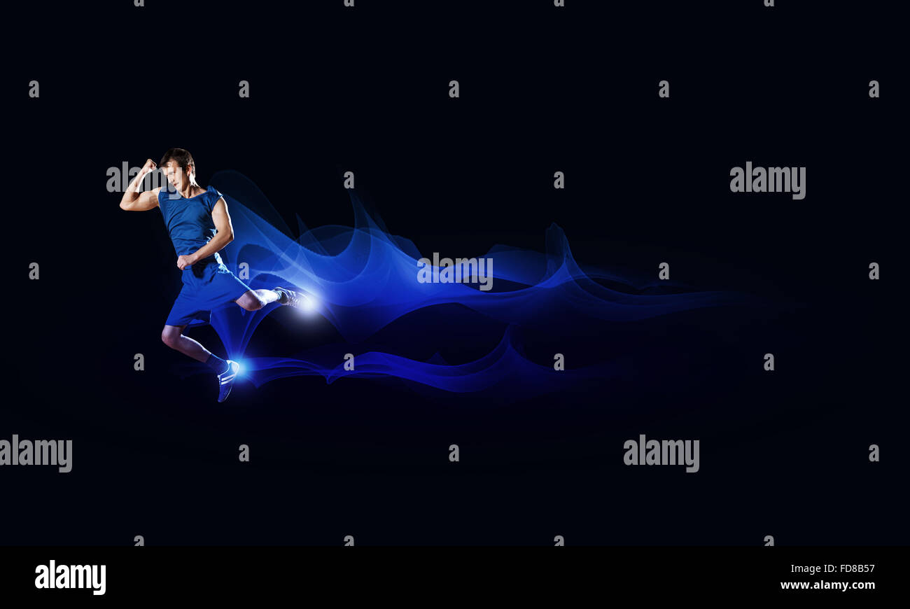 Running man in blue sport wear on black background Stock Photo - Alamy