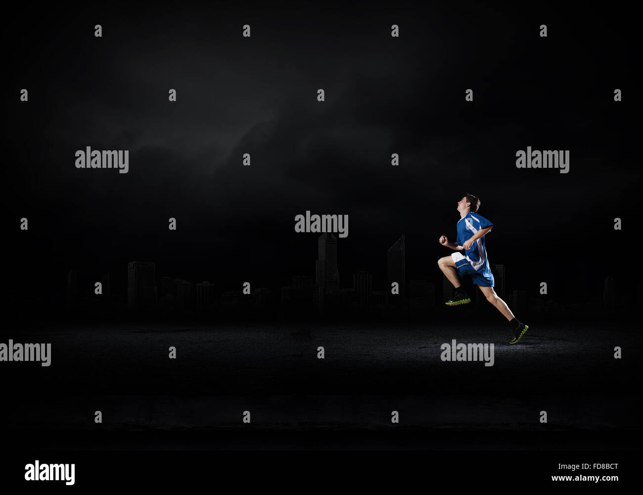 Running man in blue sport wear on black background Stock Photo - Alamy