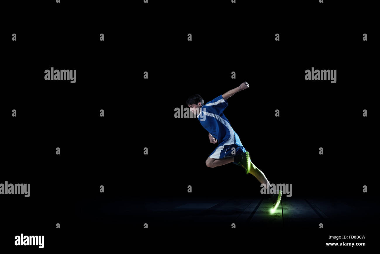 Running man in blue sport wear on black background Stock Photo - Alamy