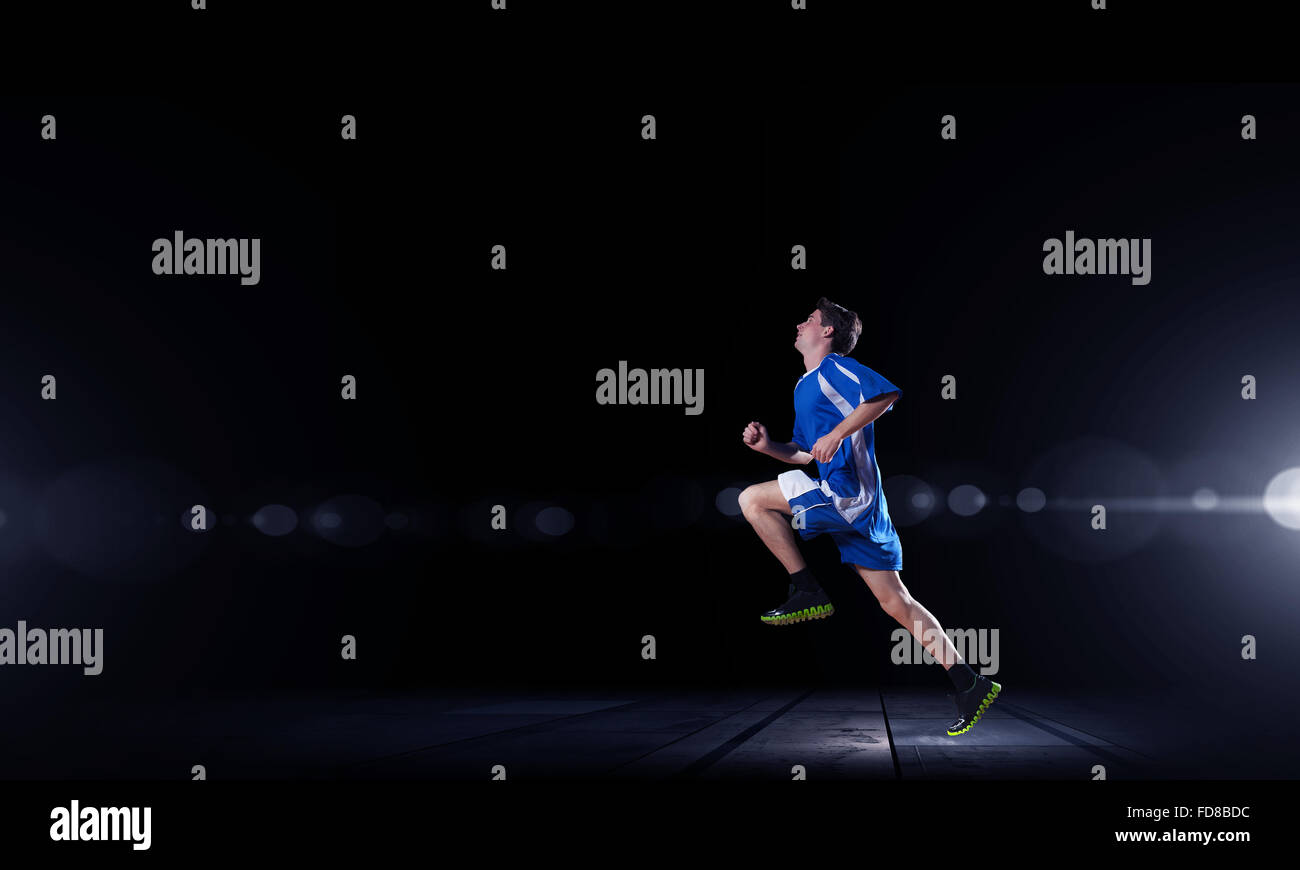 Running man in blue sport wear on black background Stock Photo - Alamy