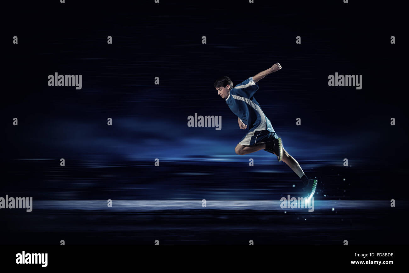Running man in blue sport wear on black background Stock Photo - Alamy