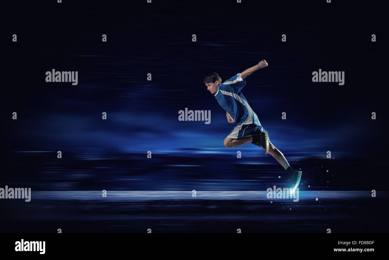 Running man in blue sport wear on black background Stock Photo - Alamy
