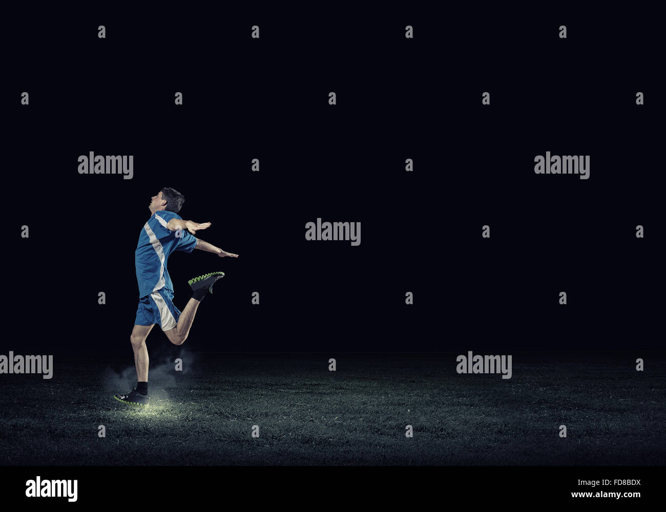Running man in blue sport wear on black background Stock Photo - Alamy