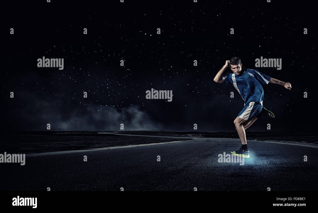 Running man in blue sport wear on black background Stock Photo - Alamy