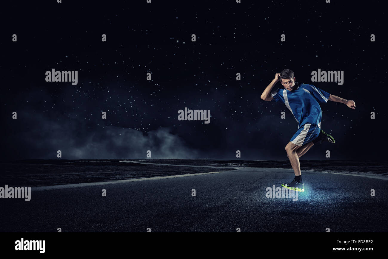 Running man in blue sport wear on black background Stock Photo - Alamy
