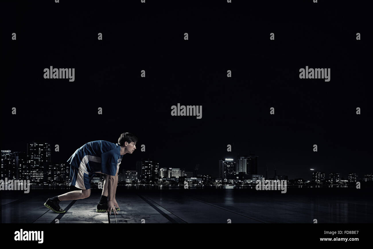 Running man in blue sport wear on black background Stock Photo - Alamy