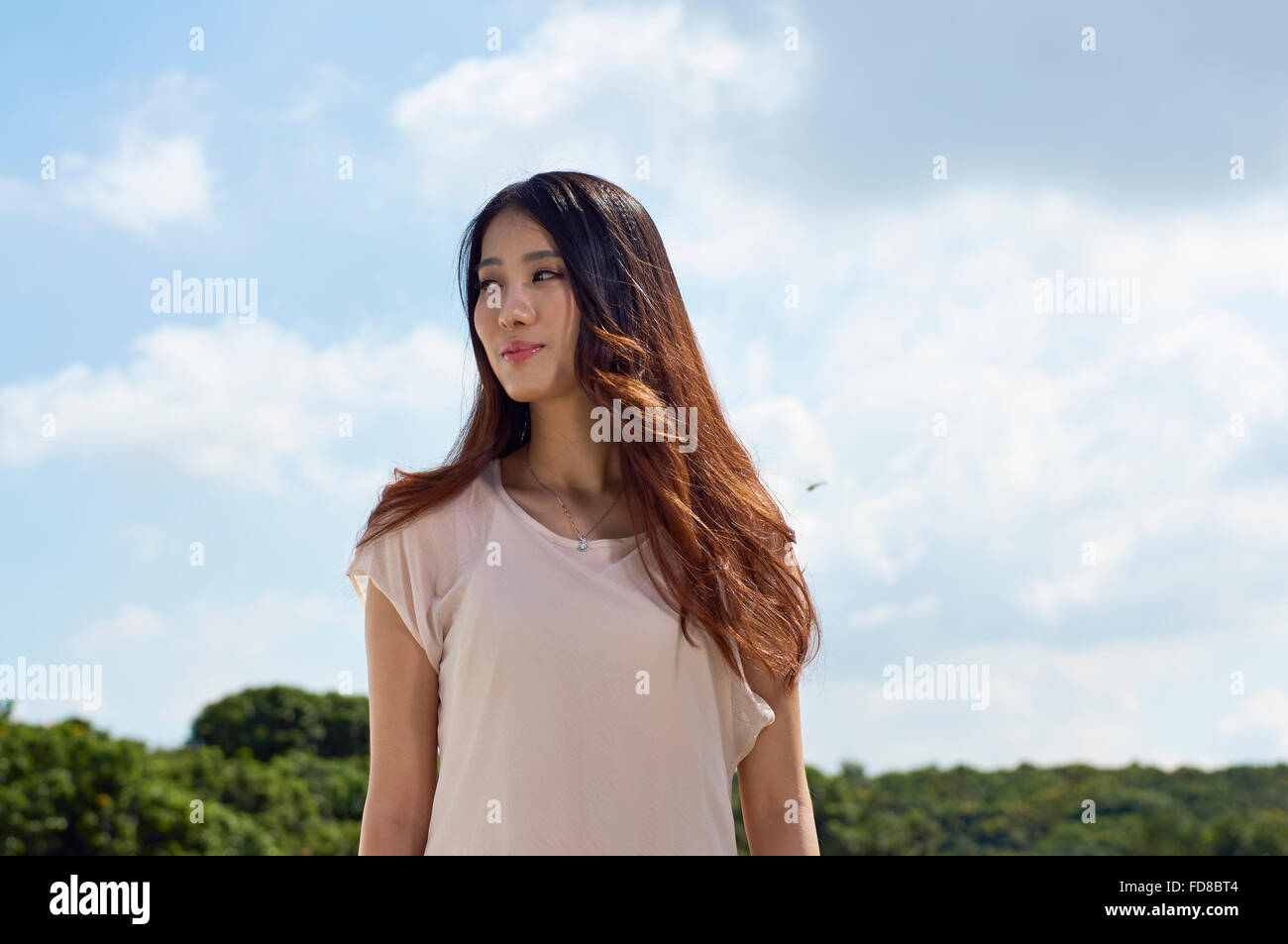 young Chinese woman smiling in nature Stock Photo - Alamy