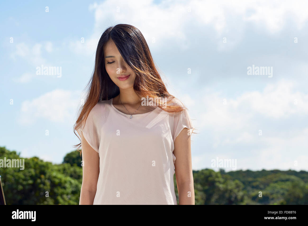 young Chinese beauty smiling in nature Stock Photo - Alamy