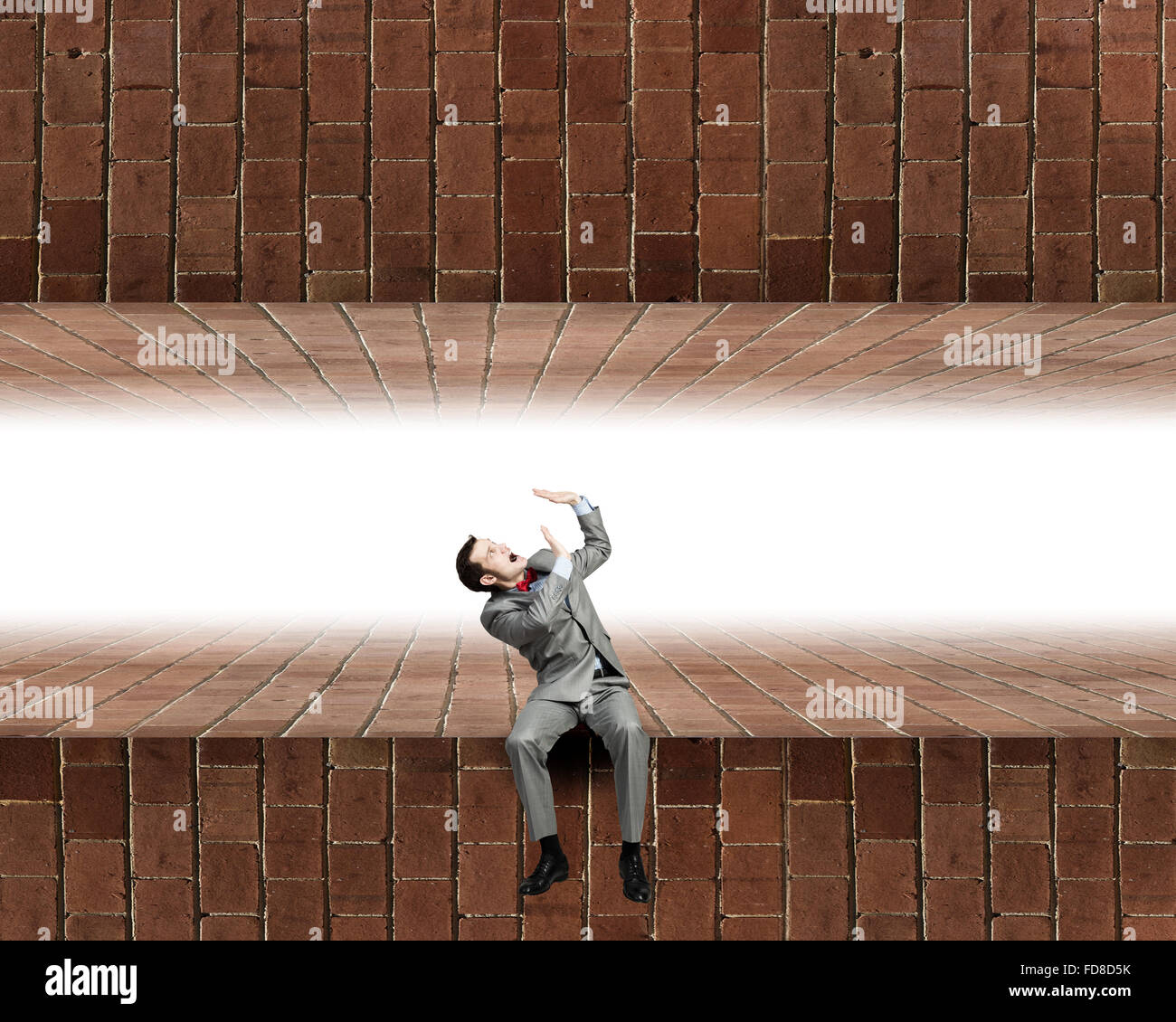 Young scared businessman sitting and looking up Stock Photo - Alamy