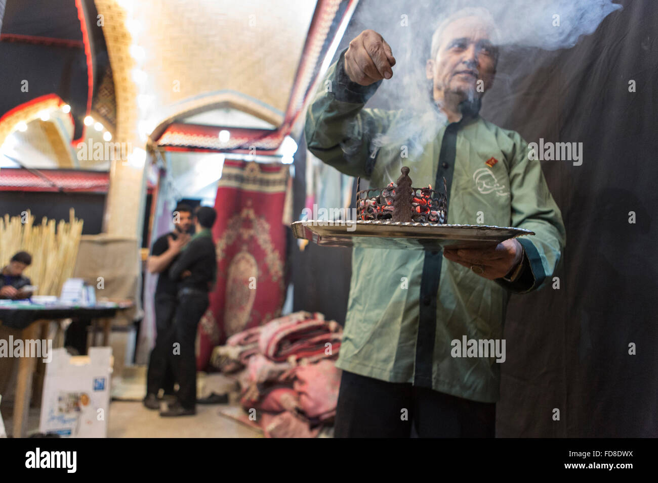 Man buring esfand in a Hosseinie in Kashan during Moharram, Iran Stock ...