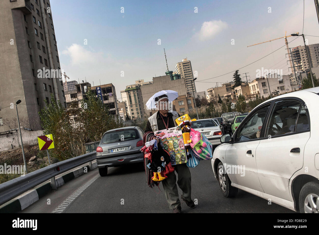 Afghan selling objects in middle of heavy traffic in Tehran, Iran Stock ...