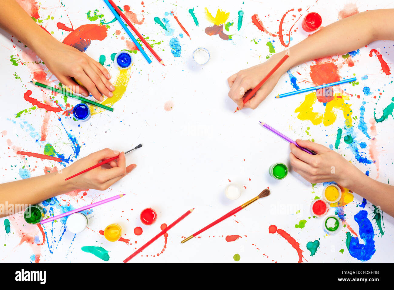 Close up of a human hands painting with gouache on white paper Stock ...