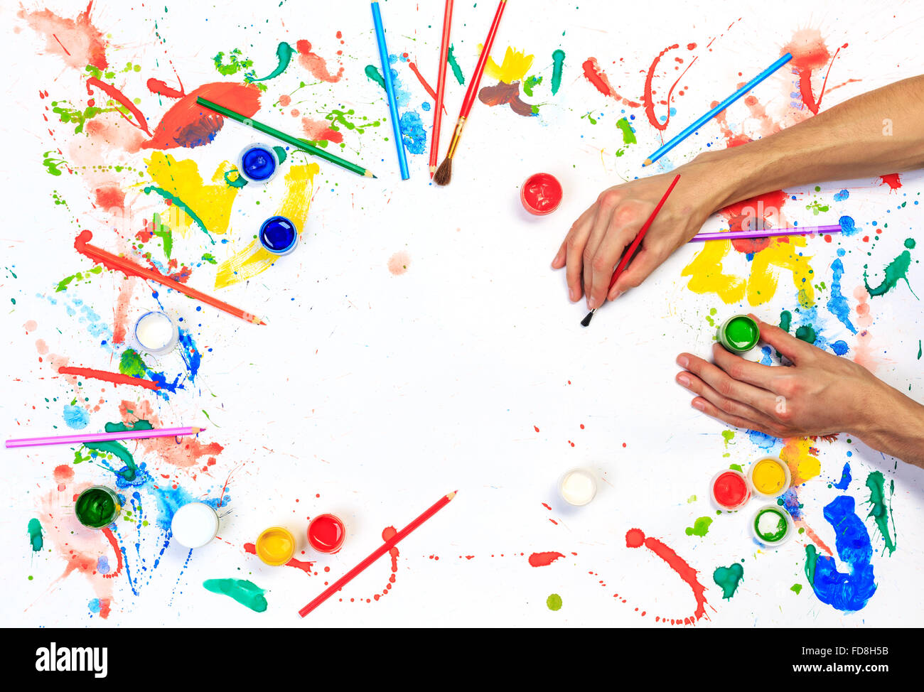 Close up of a human hands painting with gouache on white paper Stock ...