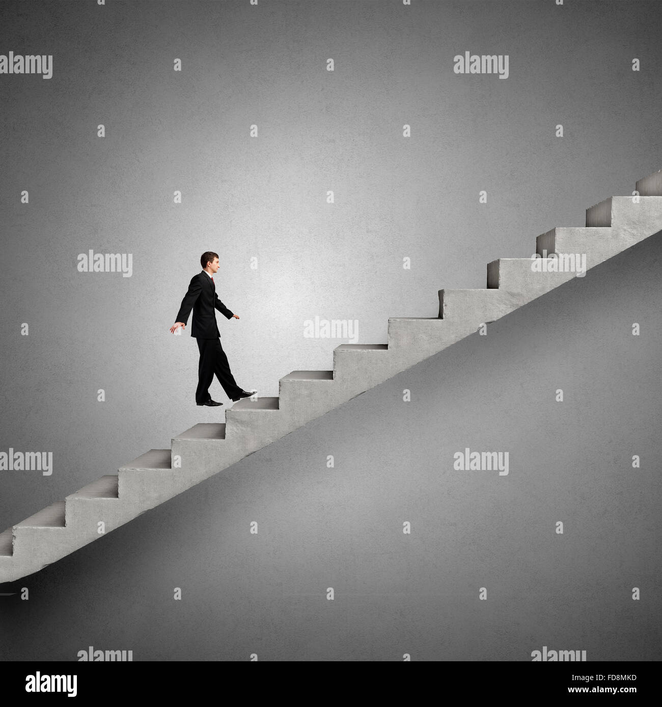 Young businessman walking up on staircase representing success concept ...