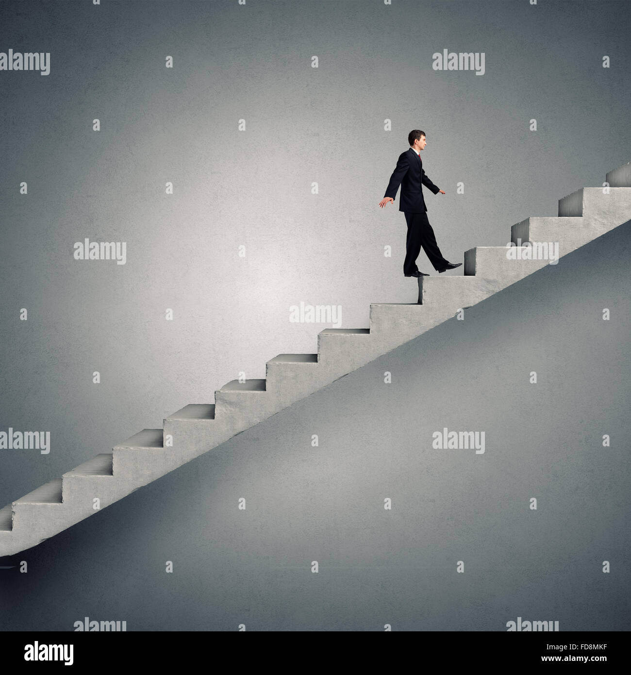 Young businessman walking up on staircase representing success concept ...