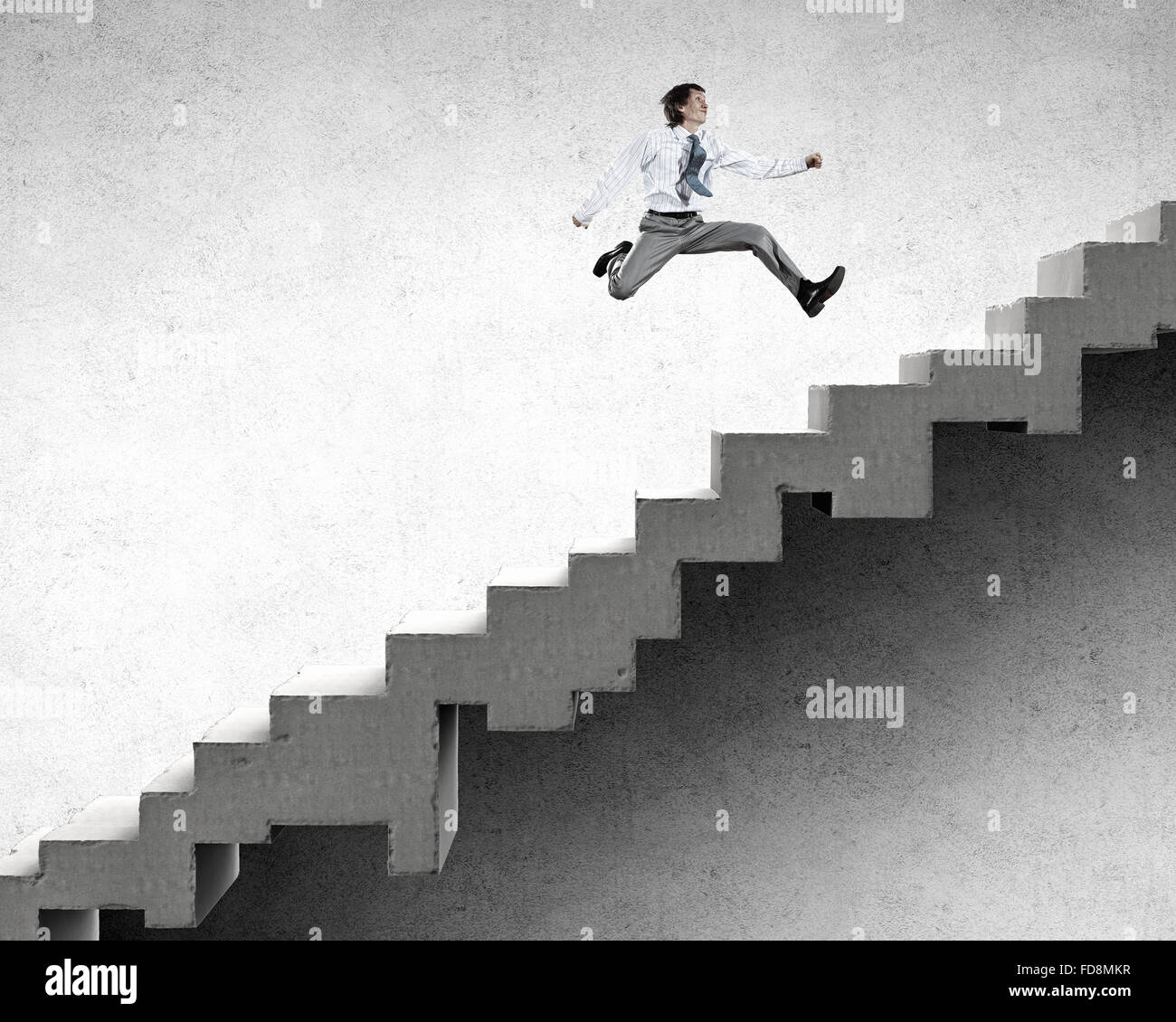 Young businessman walking up on staircase representing success concept ...