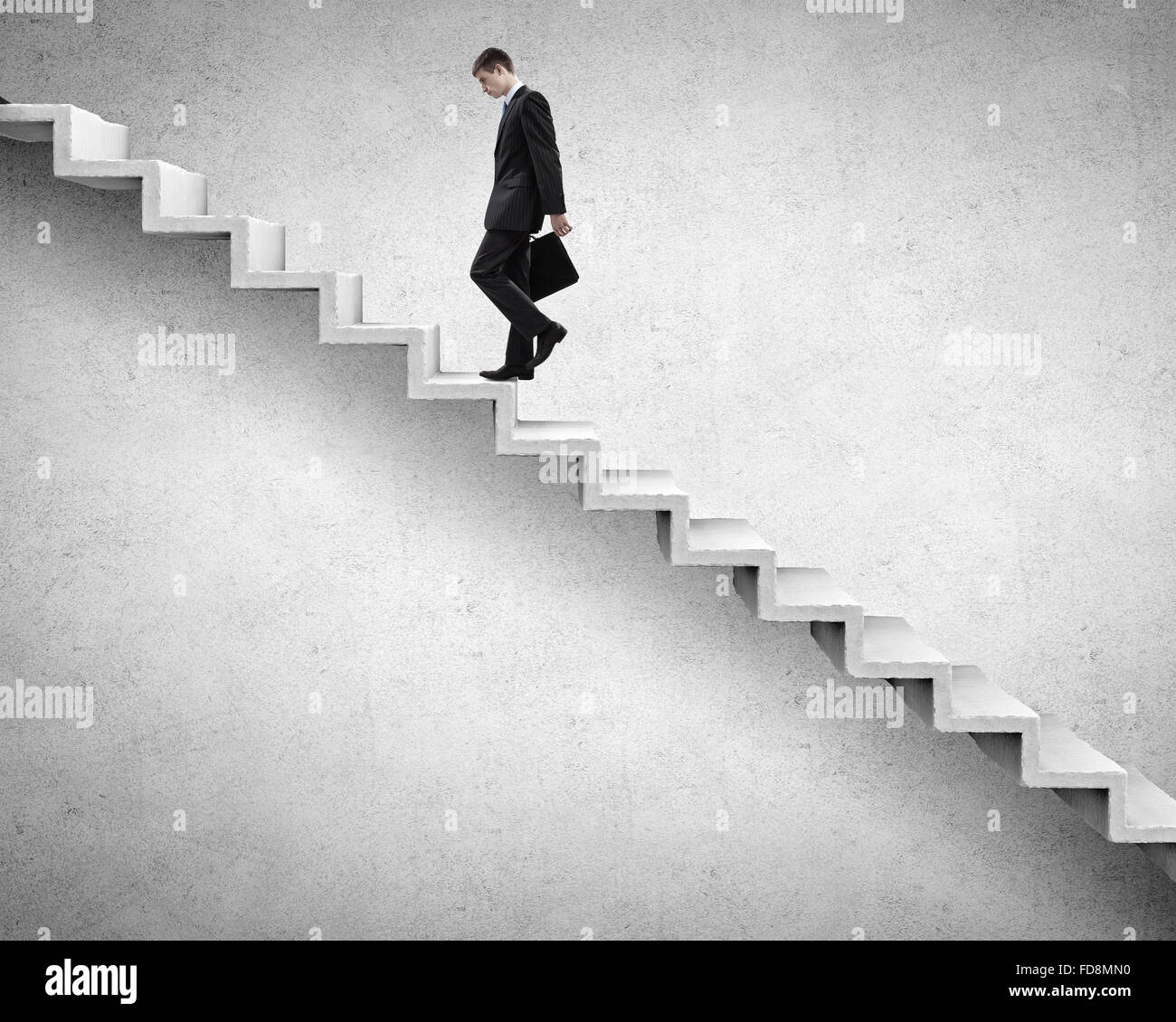 Young businessman walking up on staircase representing success concept ...