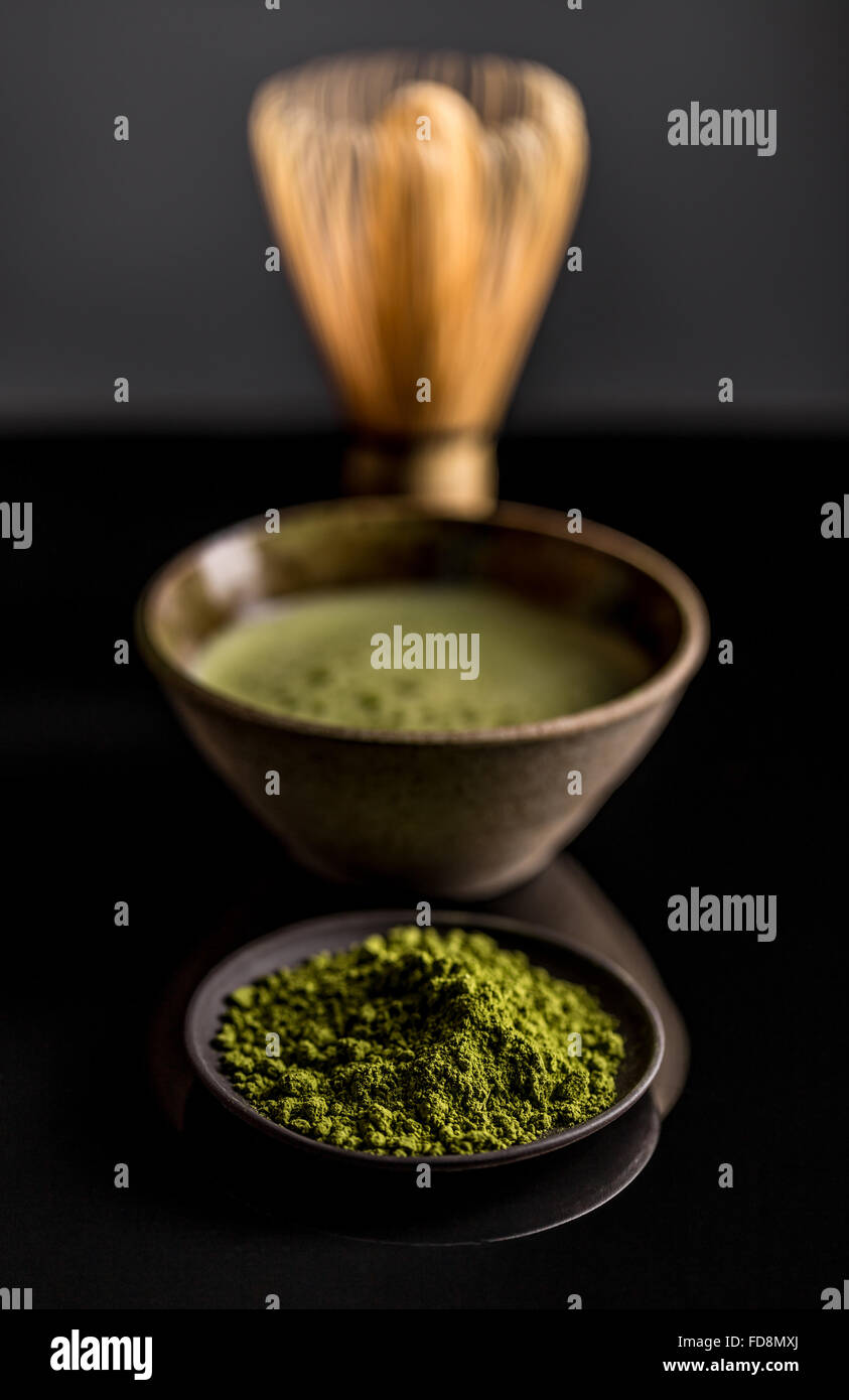 Organic green matcha tea on black background Stock Photo - Alamy