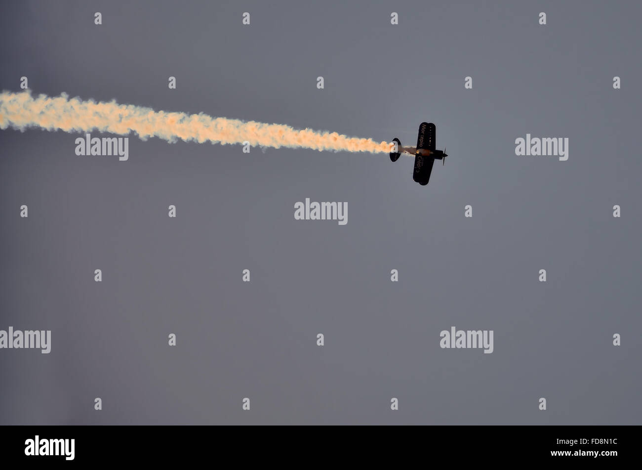 Acrobatic plane doing stunts and dropping smoke Stock Photo - Alamy