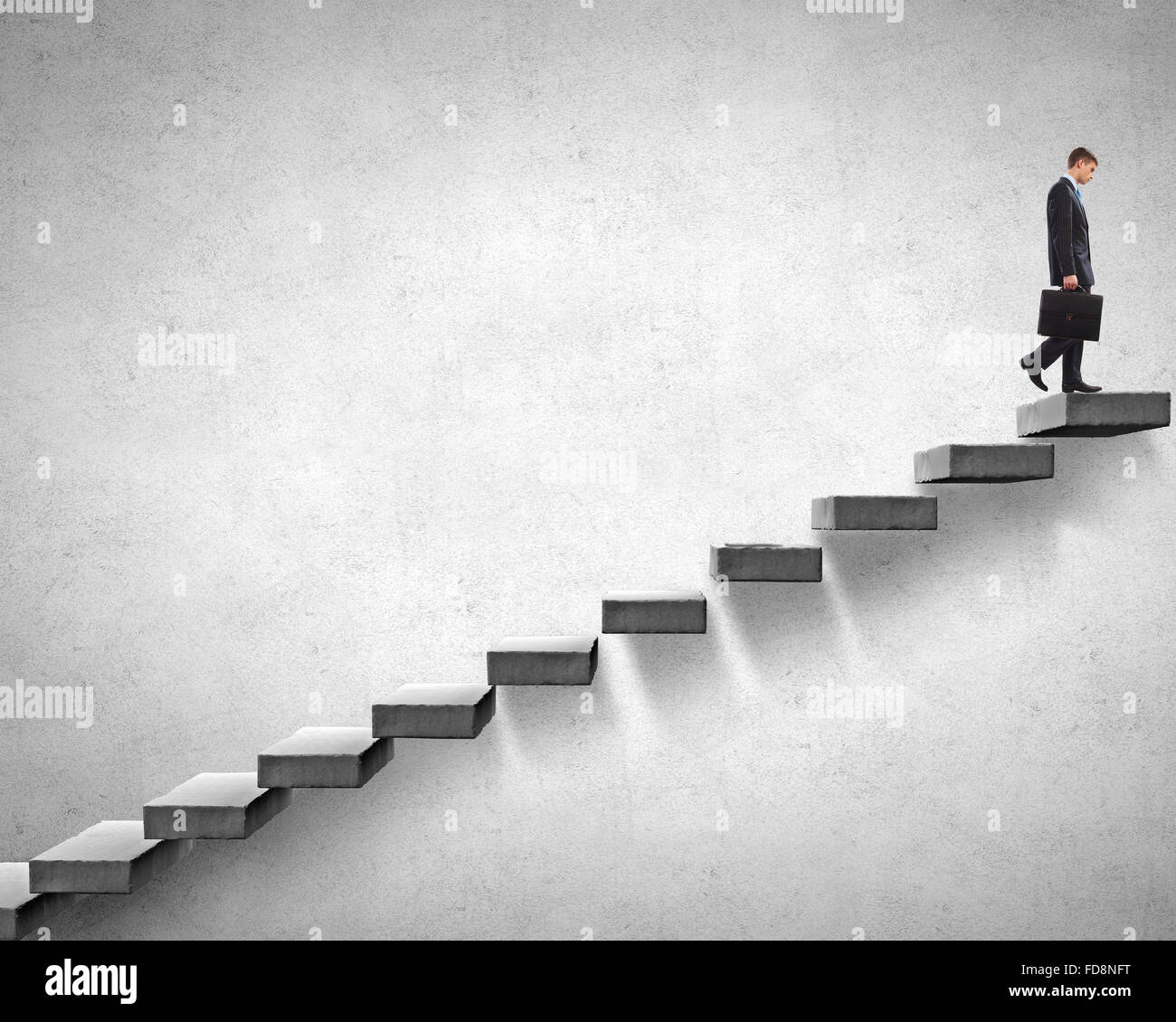 Young businessman walking up on staircase representing success concept ...