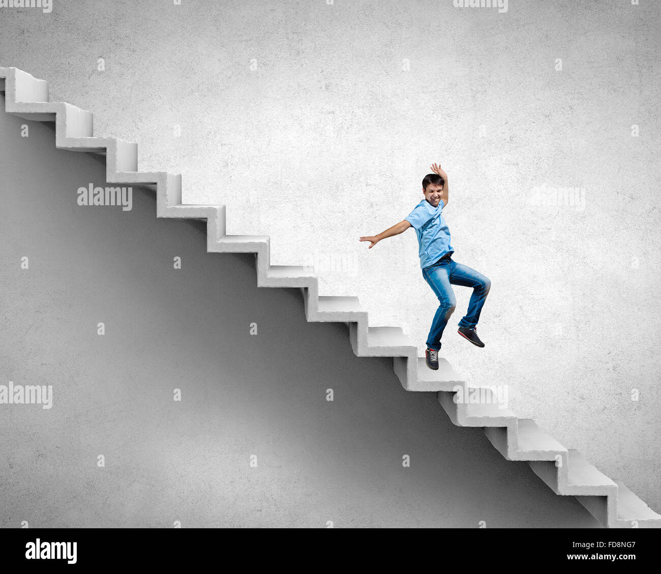 Young man walking up on staircase representing success concept Stock ...