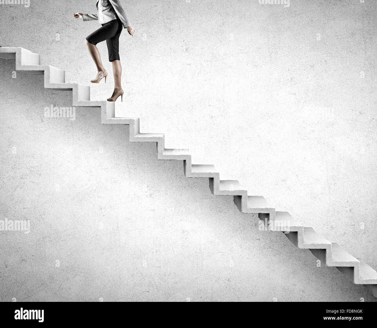 Young businesswoman walking up on staircase representing success ...