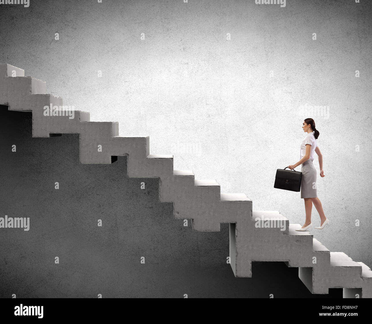 Young businesswoman walking up on staircase representing success ...