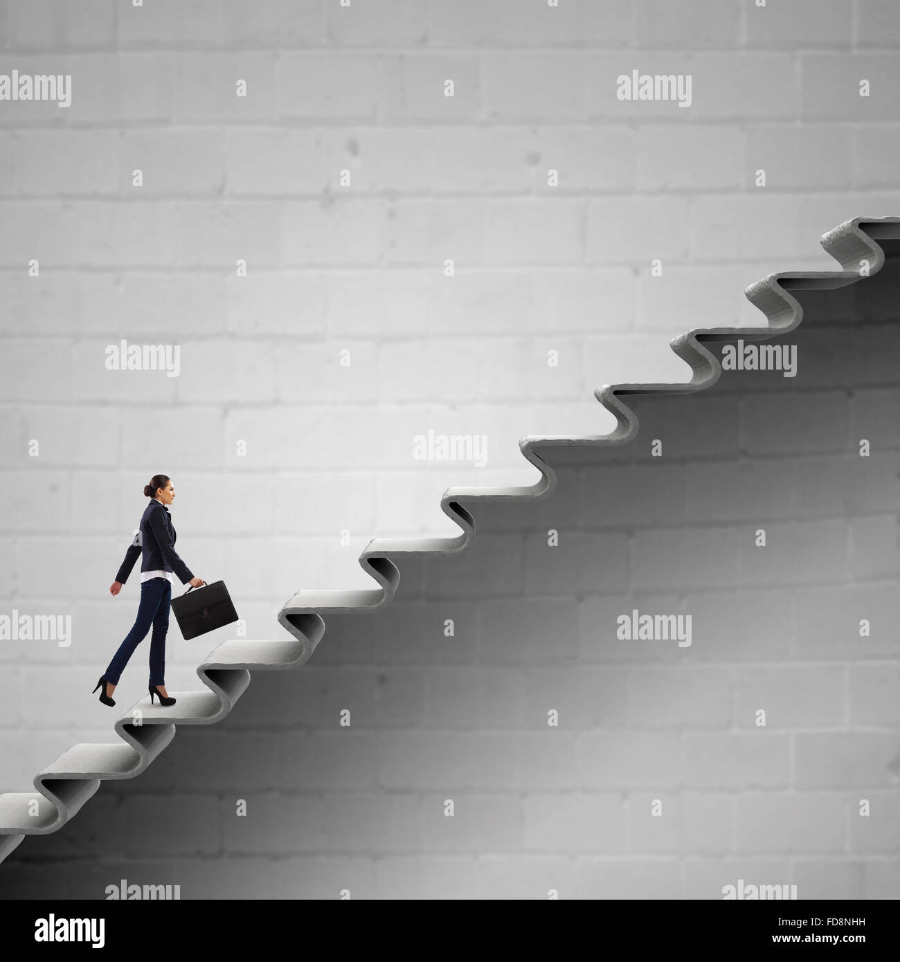 Young businesswoman walking up on staircase representing success ...