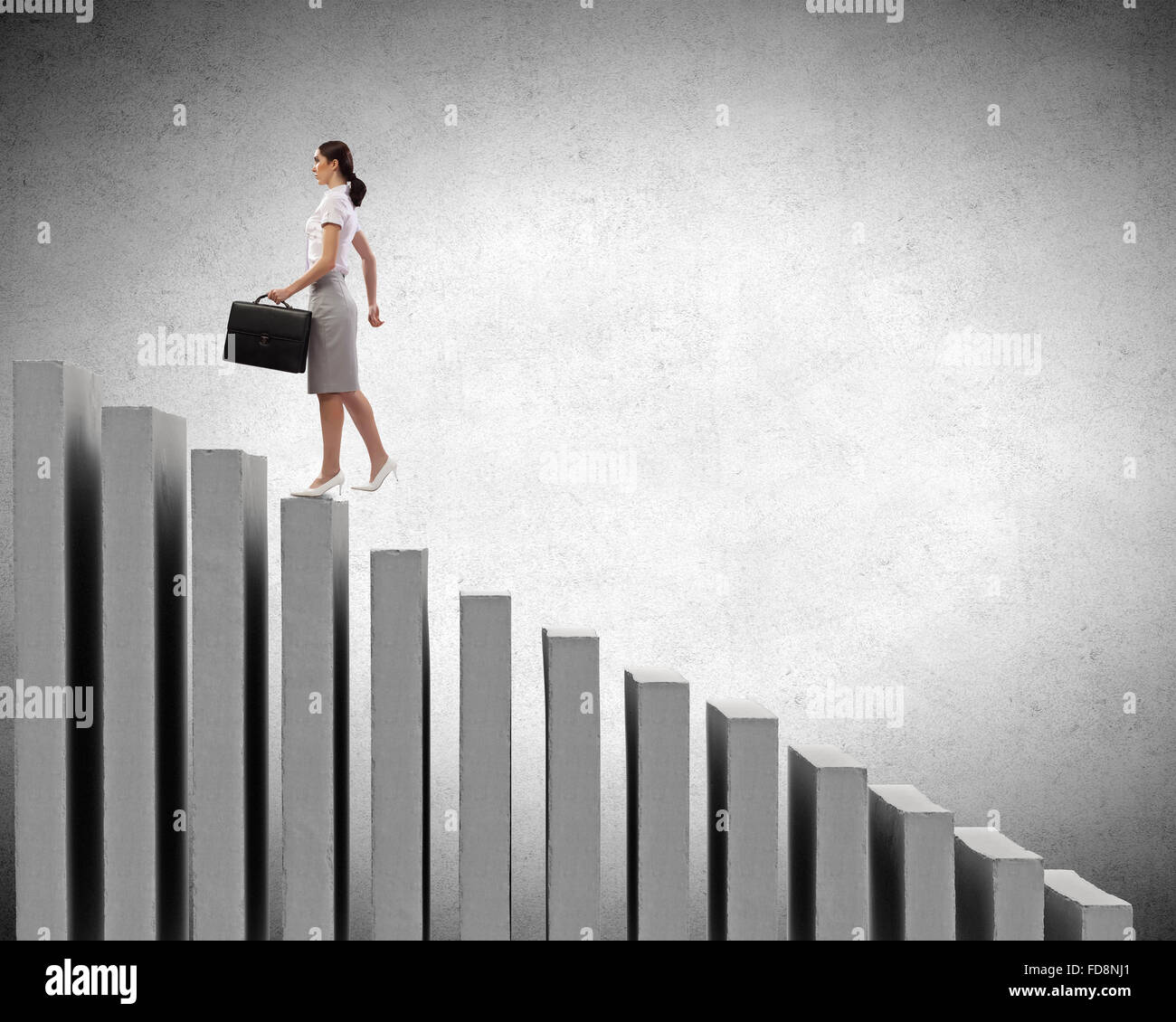 Young businesswoman walking up on staircase representing success ...