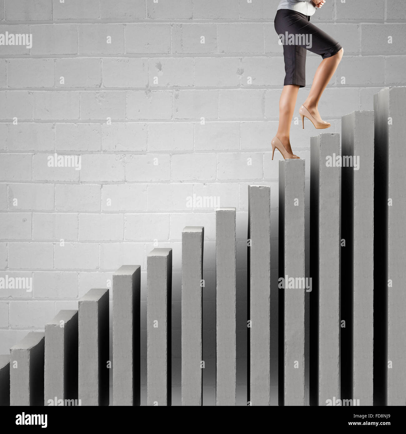 Young businesswoman walking up on staircase representing success ...