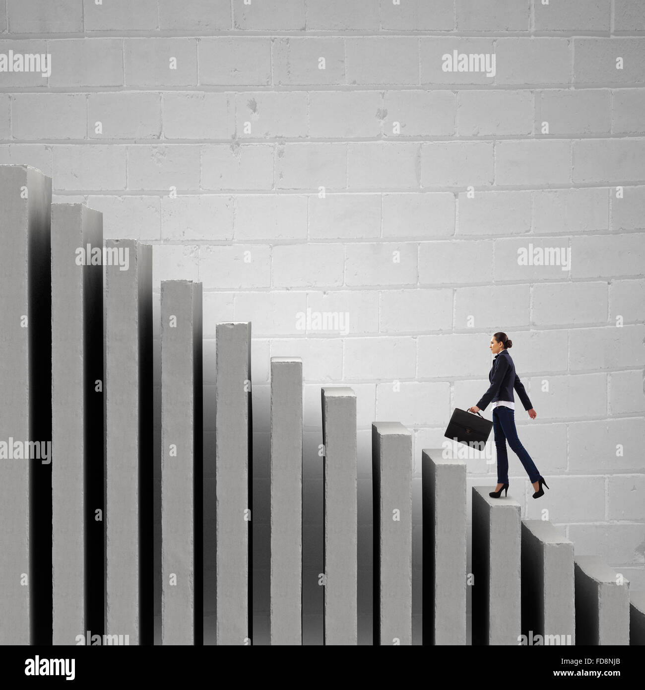Young businesswoman walking up on staircase representing success ...