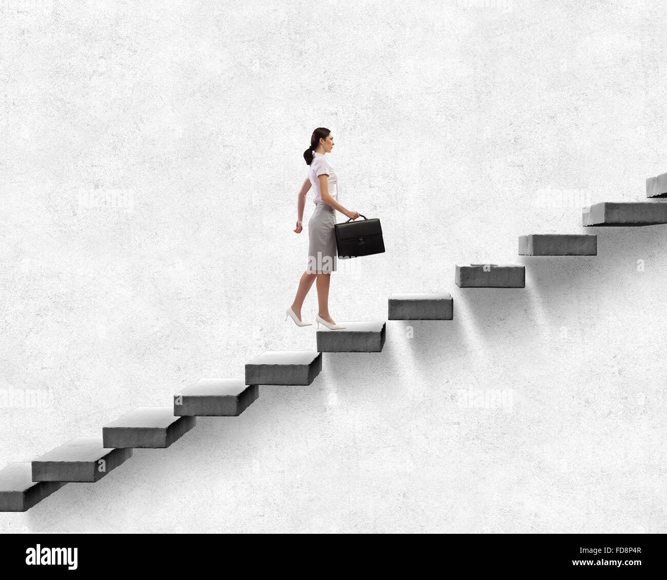 Young businesswoman walking up on staircase representing success ...