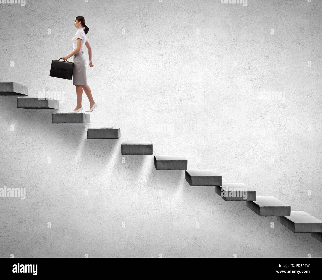 Young businesswoman walking up on staircase representing success ...