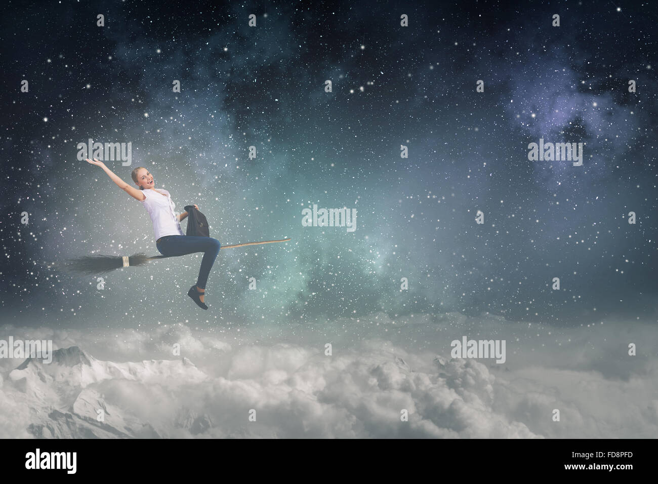 Happy young woman flying in sky on broom Stock Photo - Alamy