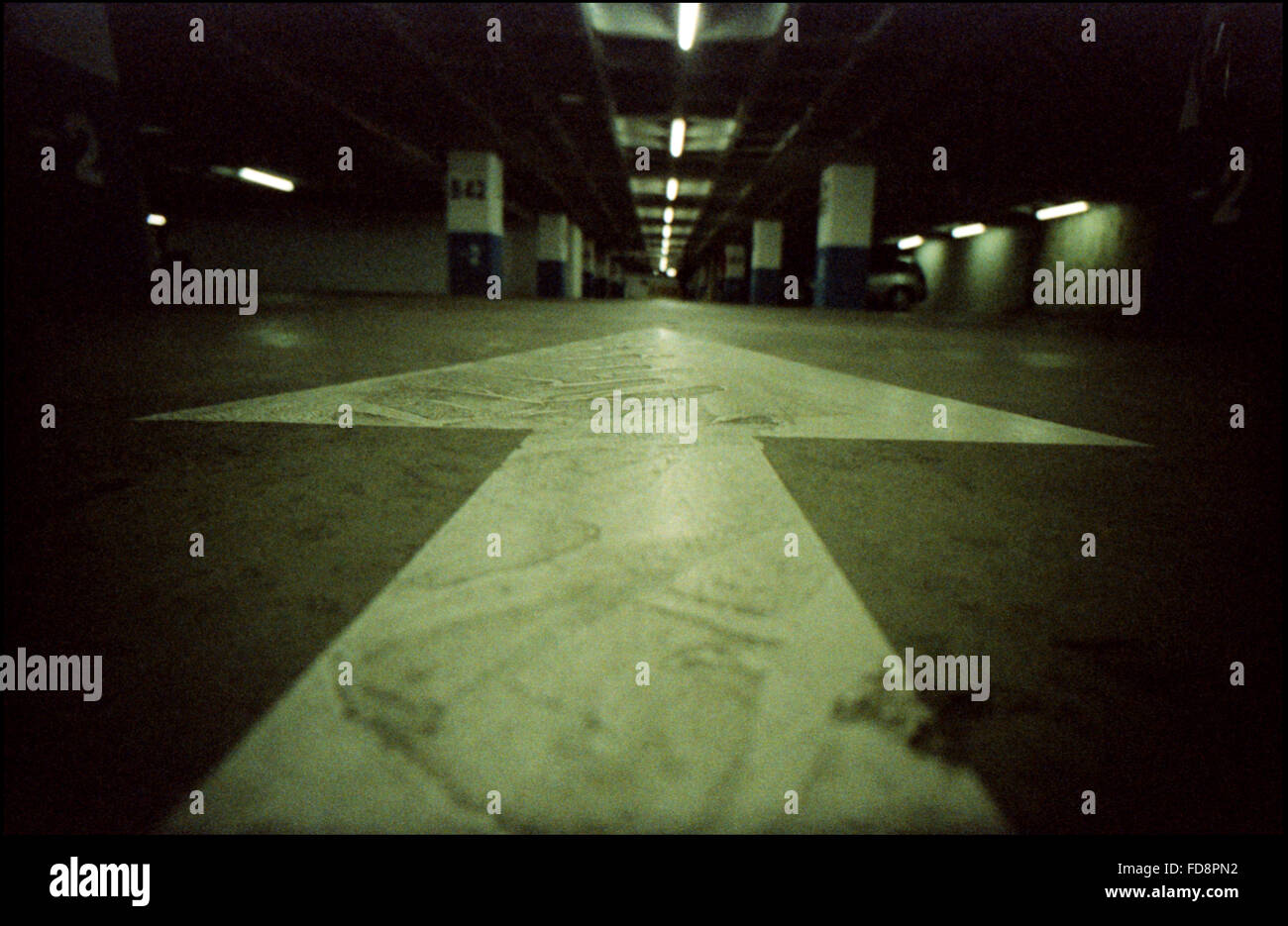 Surface Level Of Arrow Sign In Parking Garage Stock Photo - Alamy