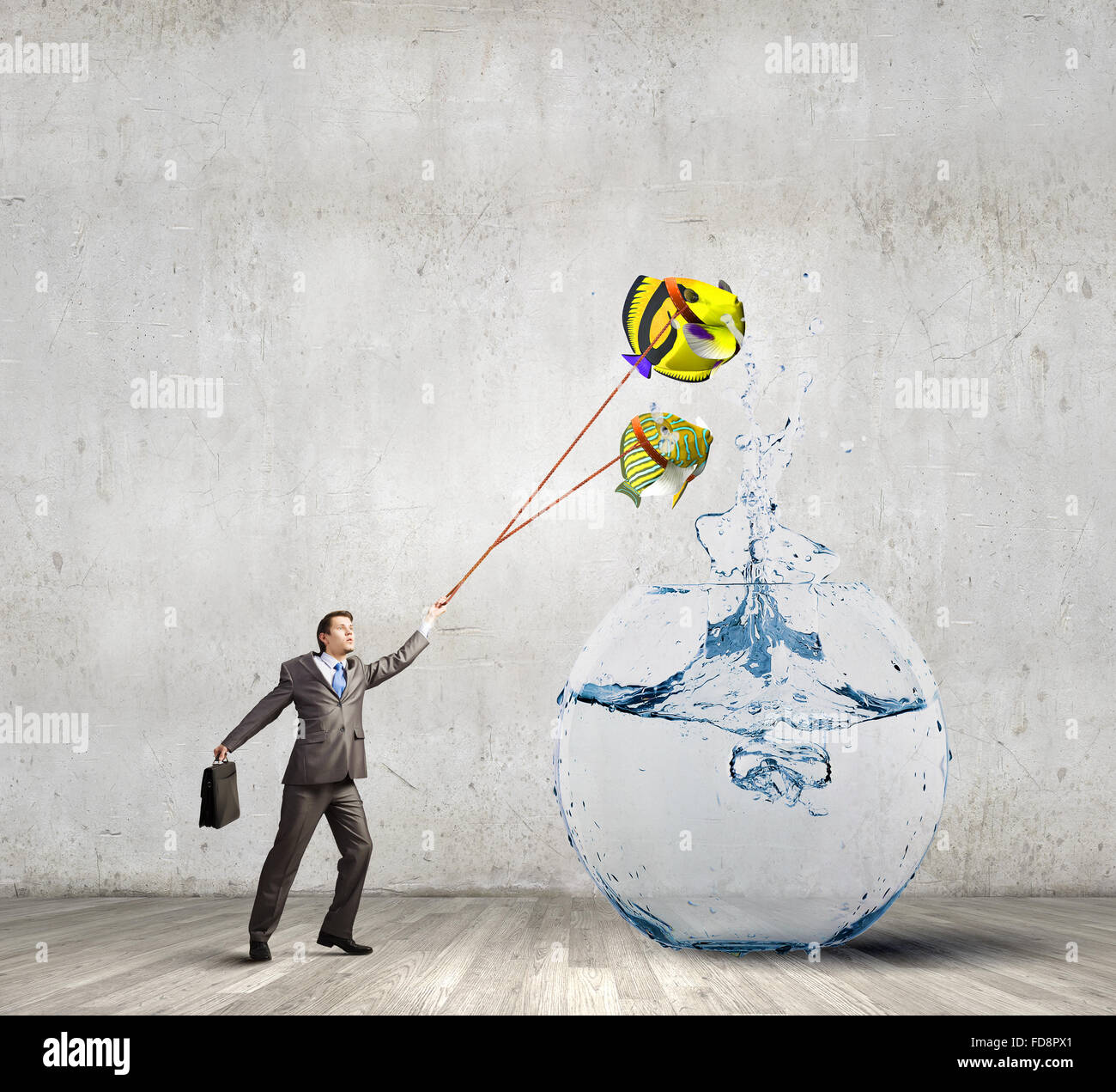 Young businessman and big exotic fish. Success in business Stock Photo ...