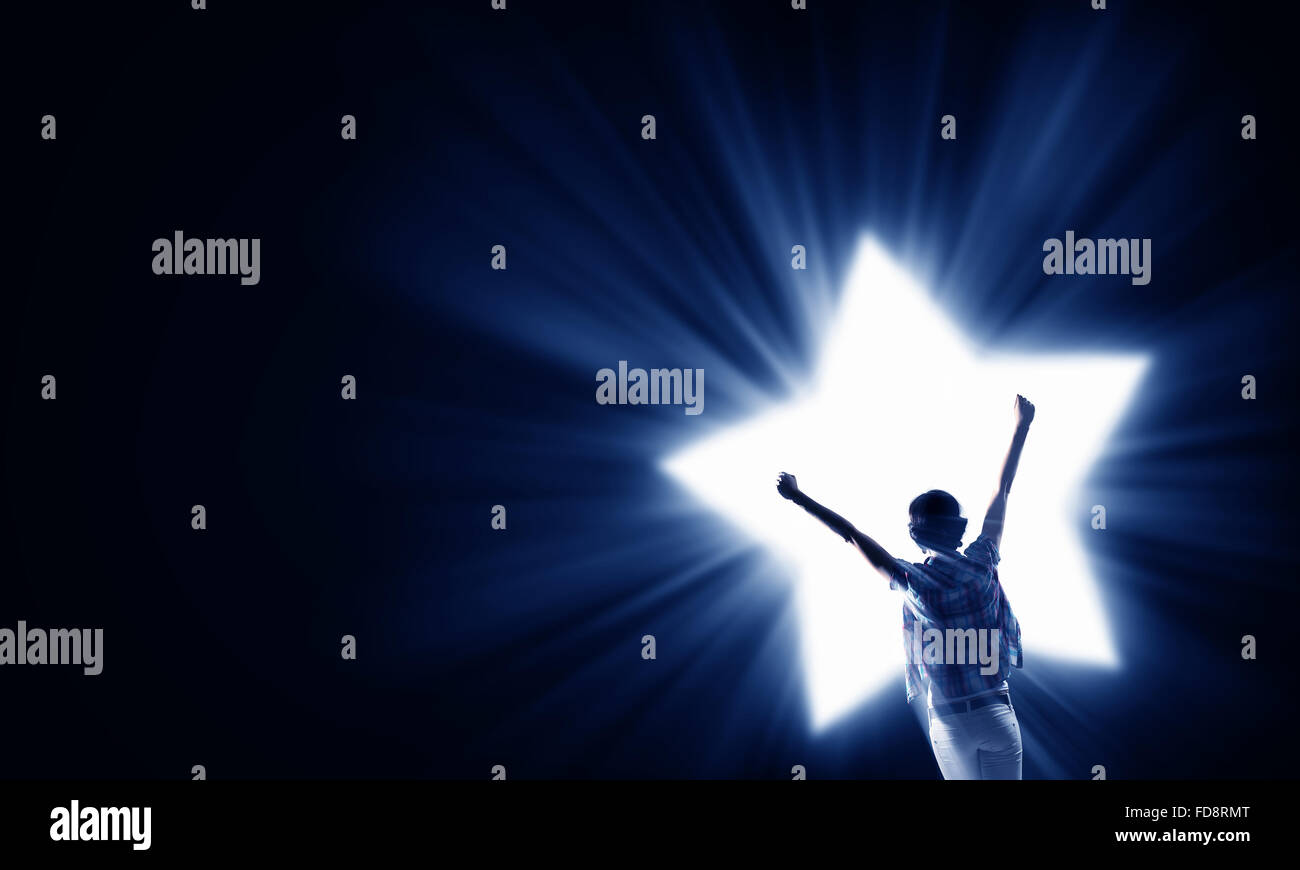 Rear view of woman with hands up facing success Stock Photo - Alamy