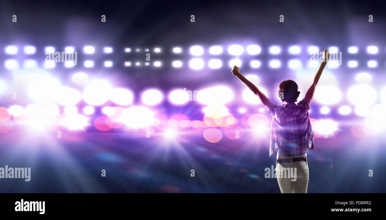 Back view of girl standing in stage lights Stock Photo - Alamy