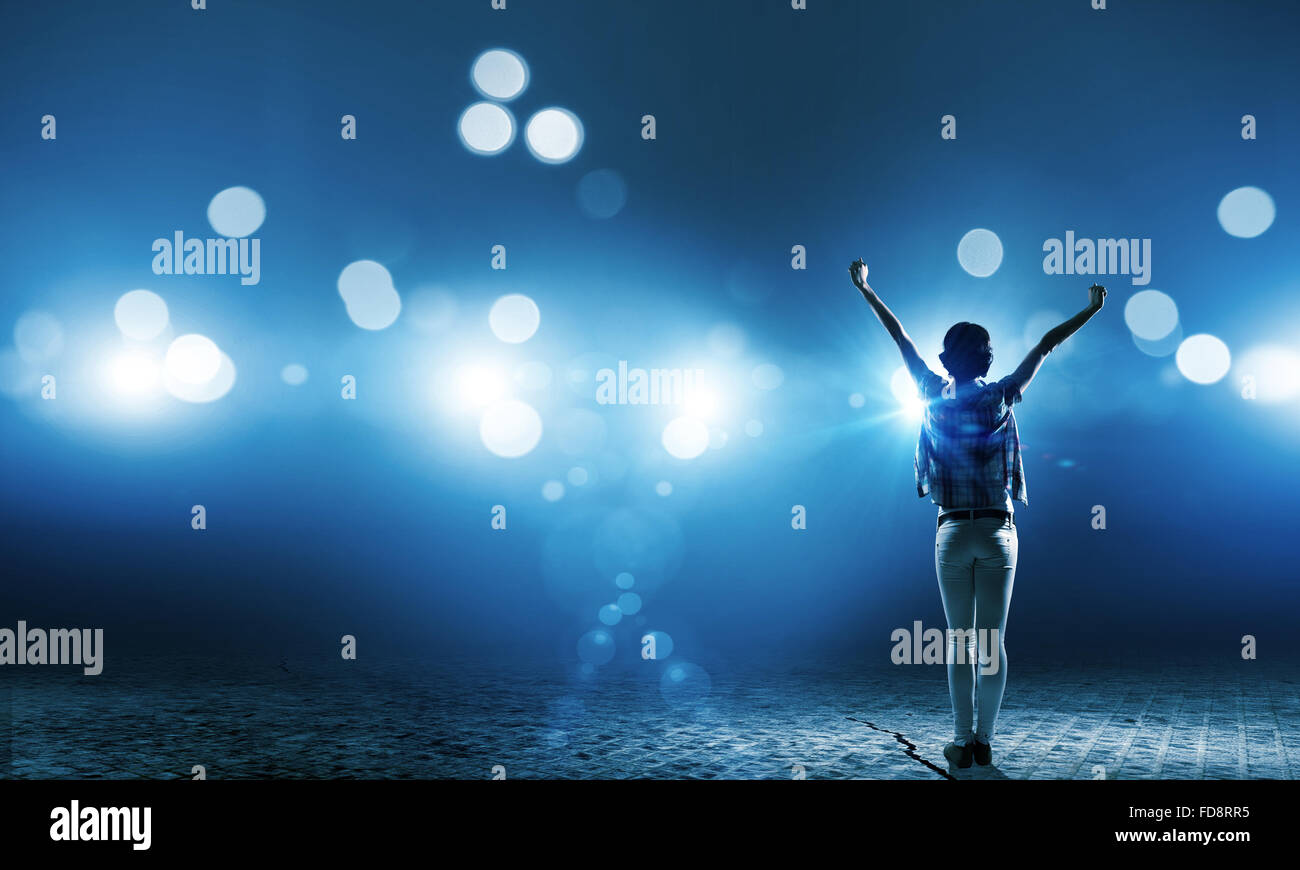 Back view of girl standing in stage lights Stock Photo - Alamy