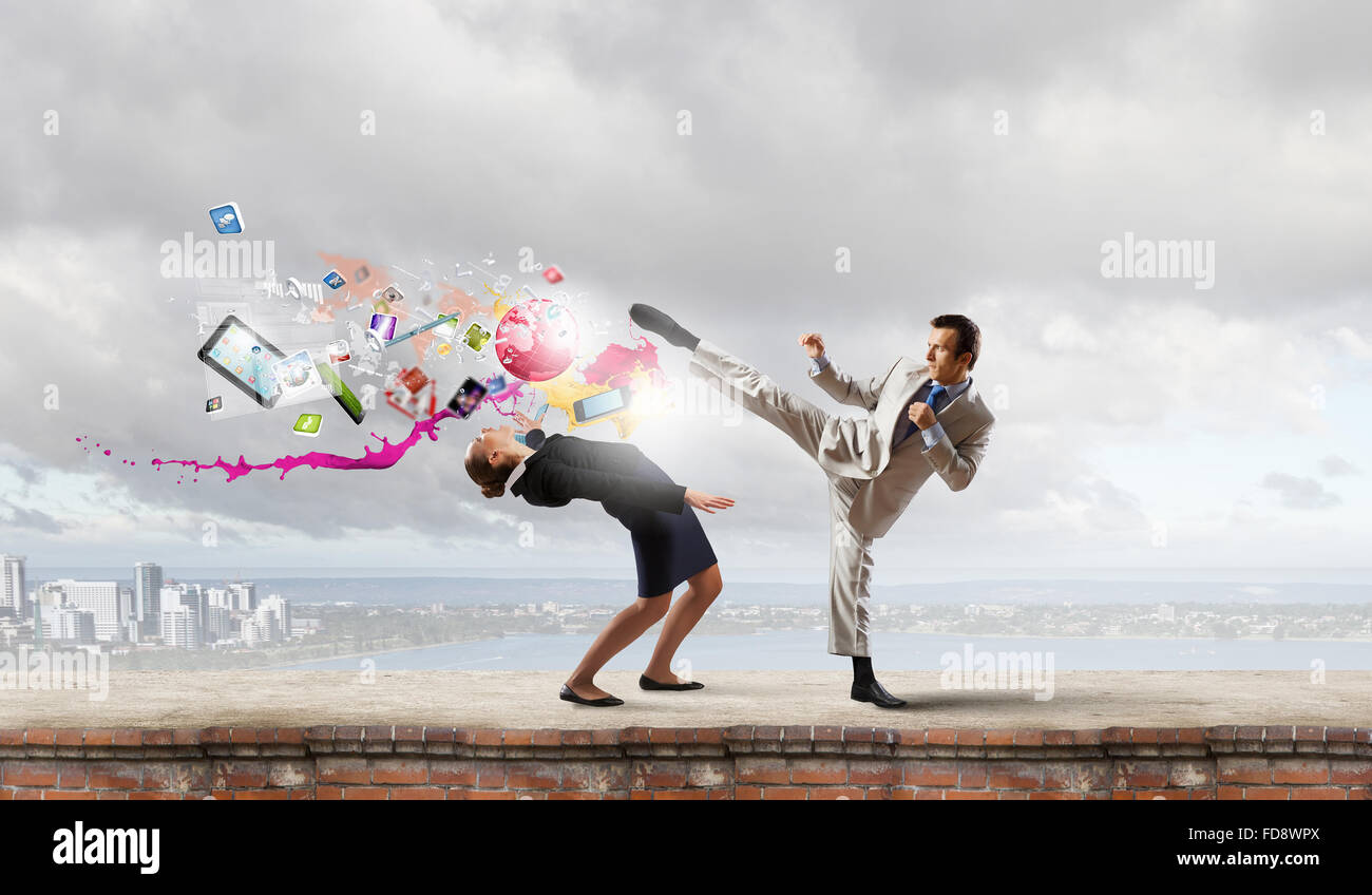 Two businesspeople in anger fighting with each other Stock Photo - Alamy