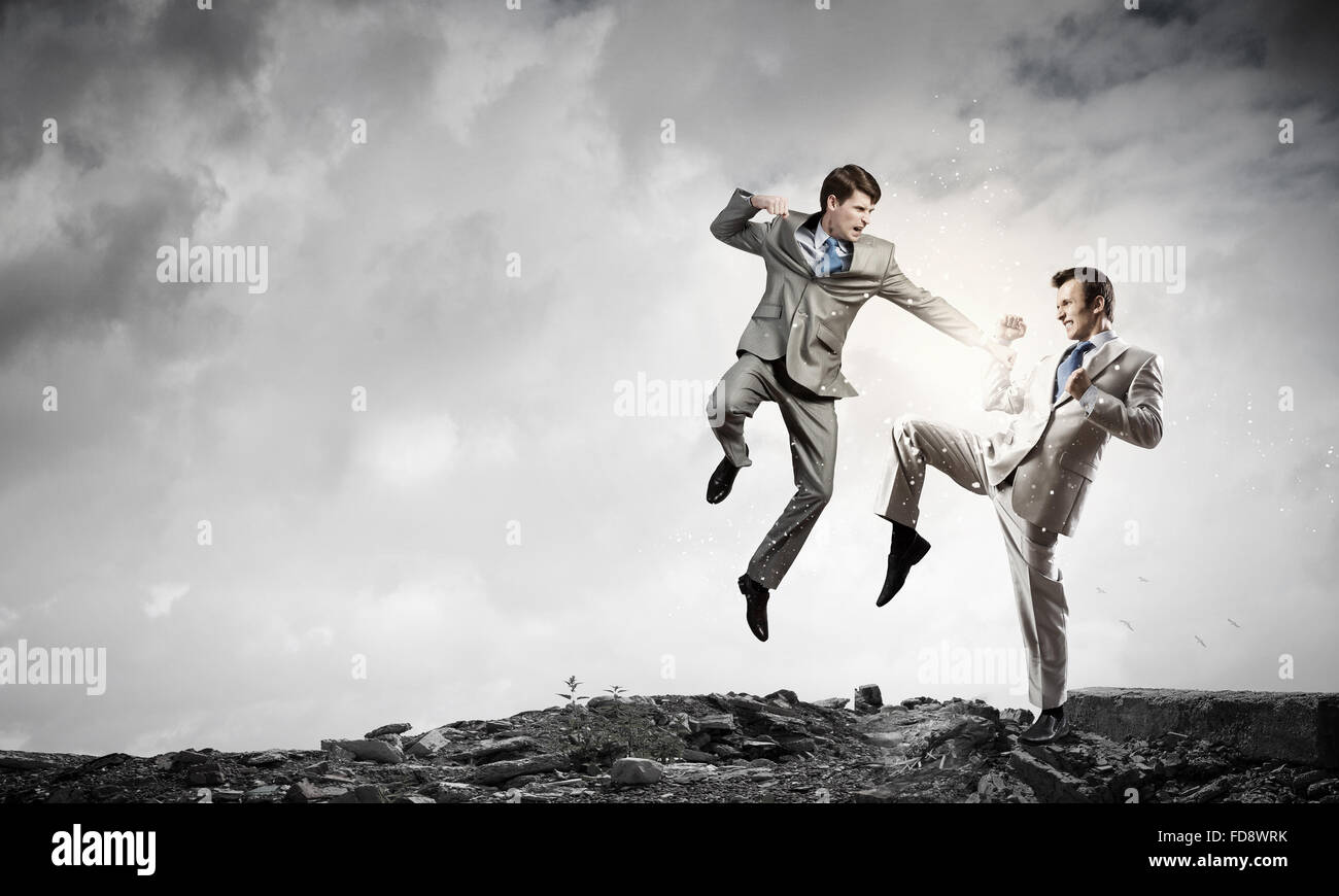 Two businesspeople in anger fighting with each other Stock Photo - Alamy
